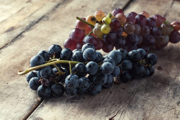 Grapes on a old wooden table.Close up photo | Puree Arete